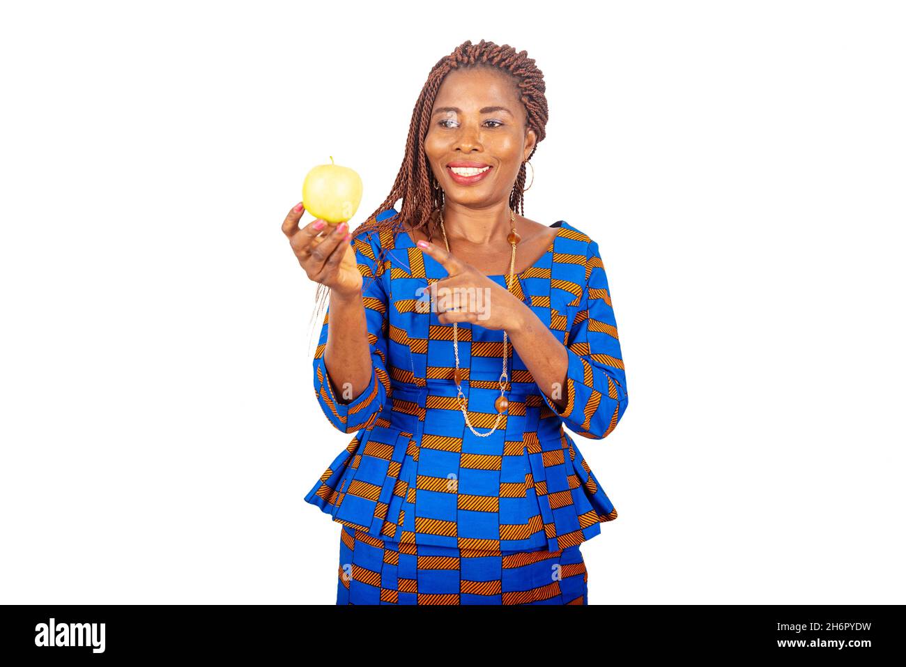 beautiful adult woman holding and pointing finger on a yellow fresh ...