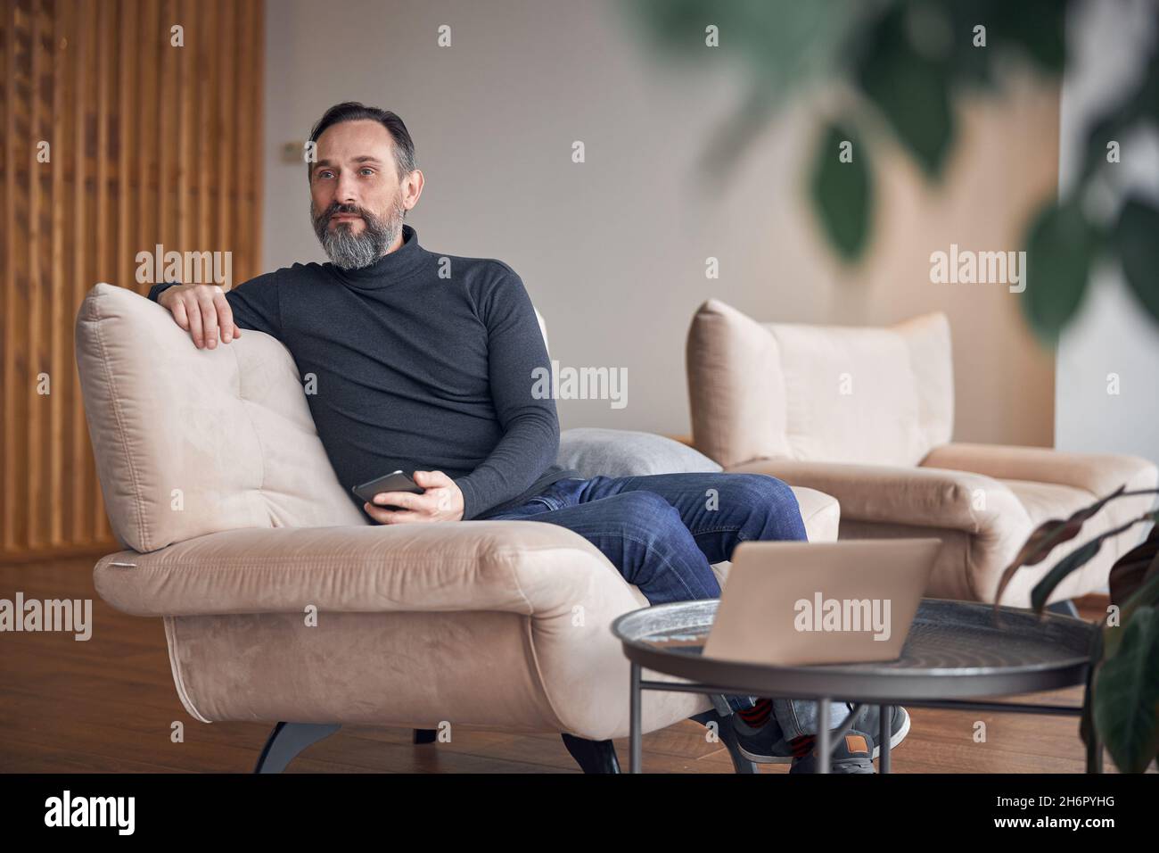 Happy adult male businessman is sitting and chilling in cozy office space Stock Photo - Alamy
