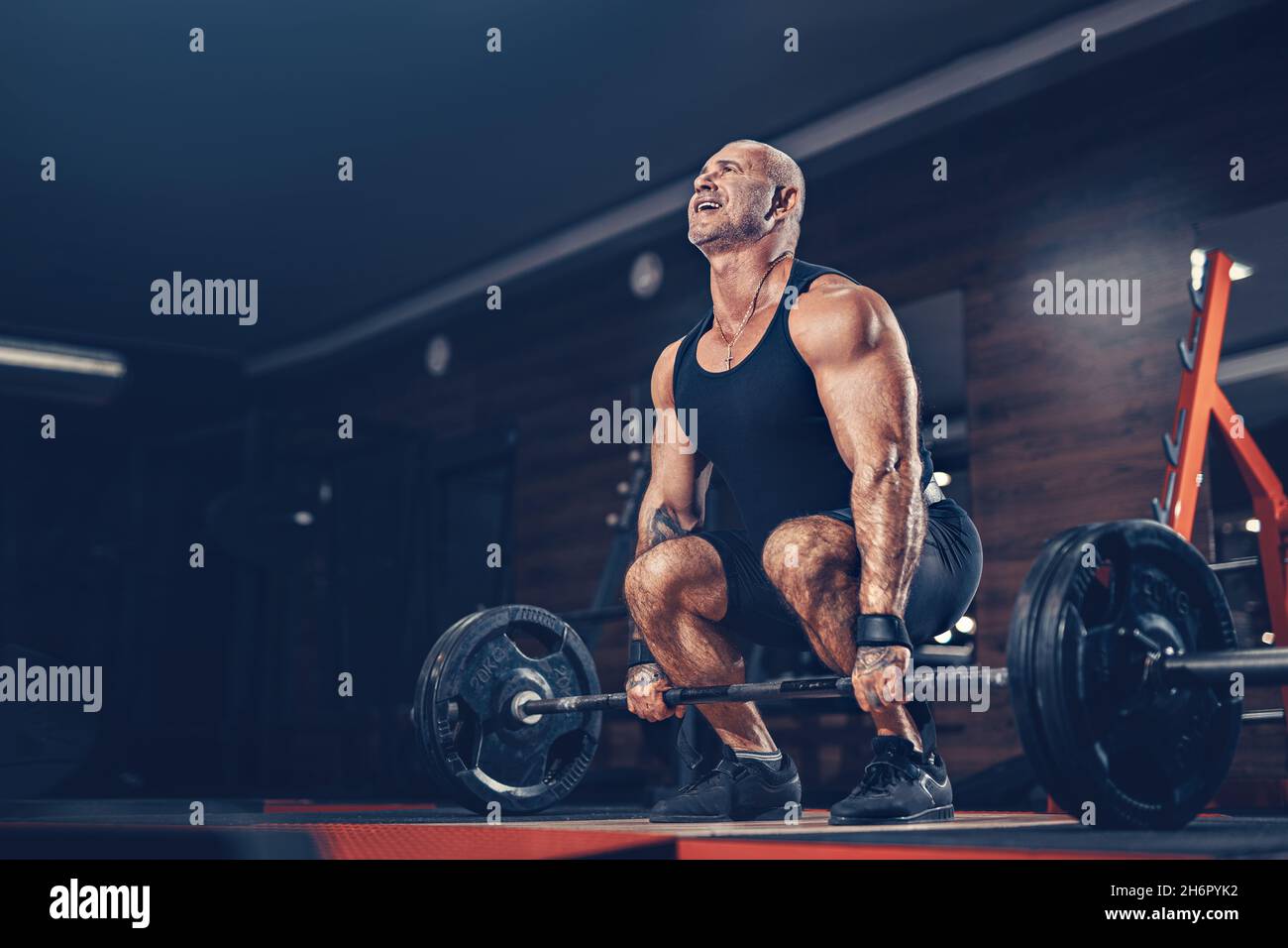 Bodybuilder muscular man doing heavy deadlift exercise with weight ...