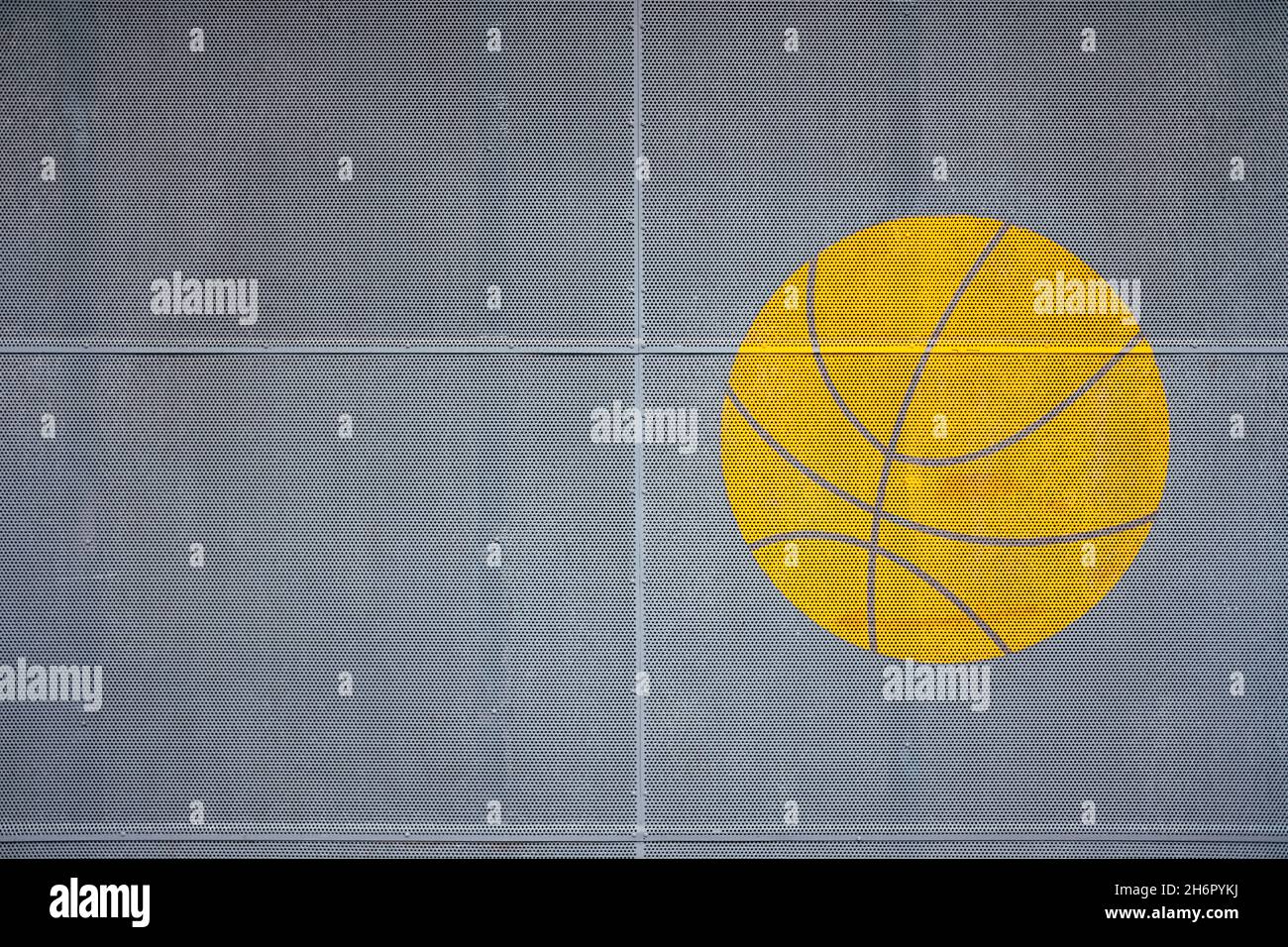 Yellow basketball ball on the fence Stock Photo - Alamy