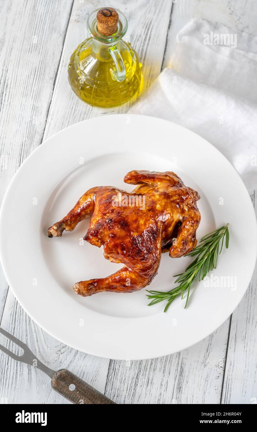 Roasted chicken on the white serving plate Stock Photo - Alamy