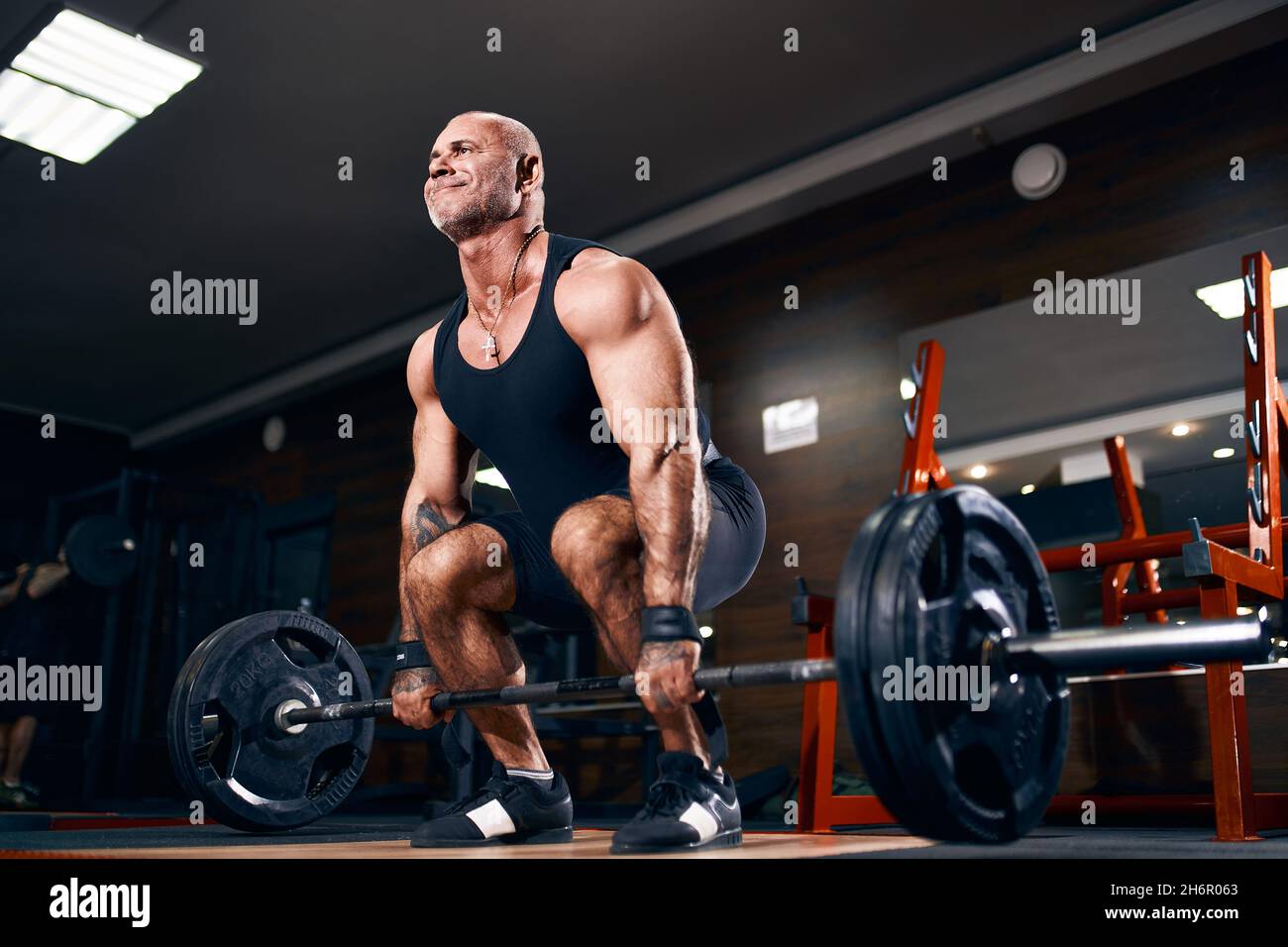 Bodybuilder muscular man doing heavy deadlift exercise with weight ...