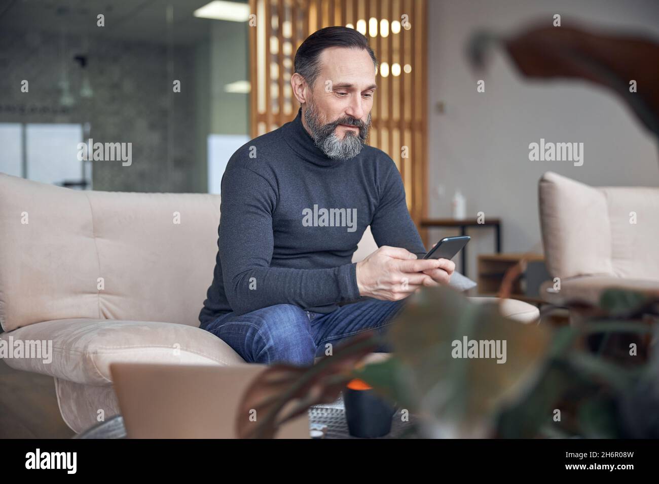 Happy adult male businessman is sitting and chilling in cozy office space Stock Photo - Alamy