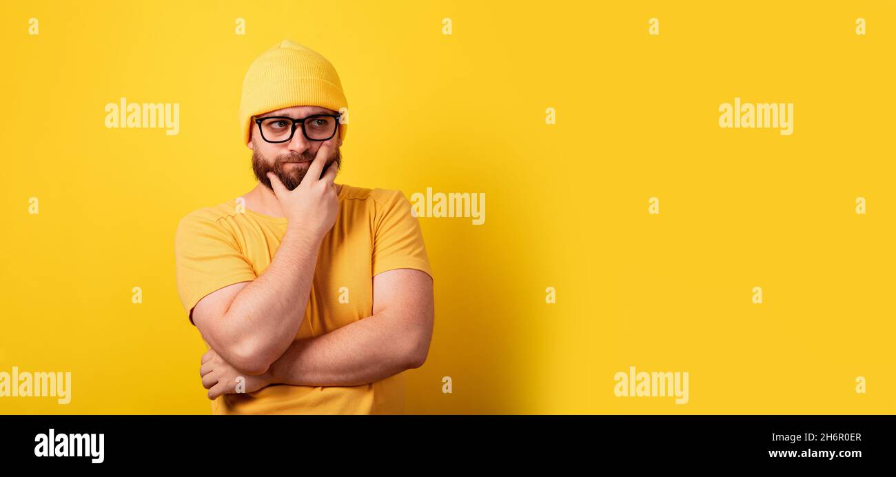 thinking man over yellow background, serious guy thinks, panoramic ...