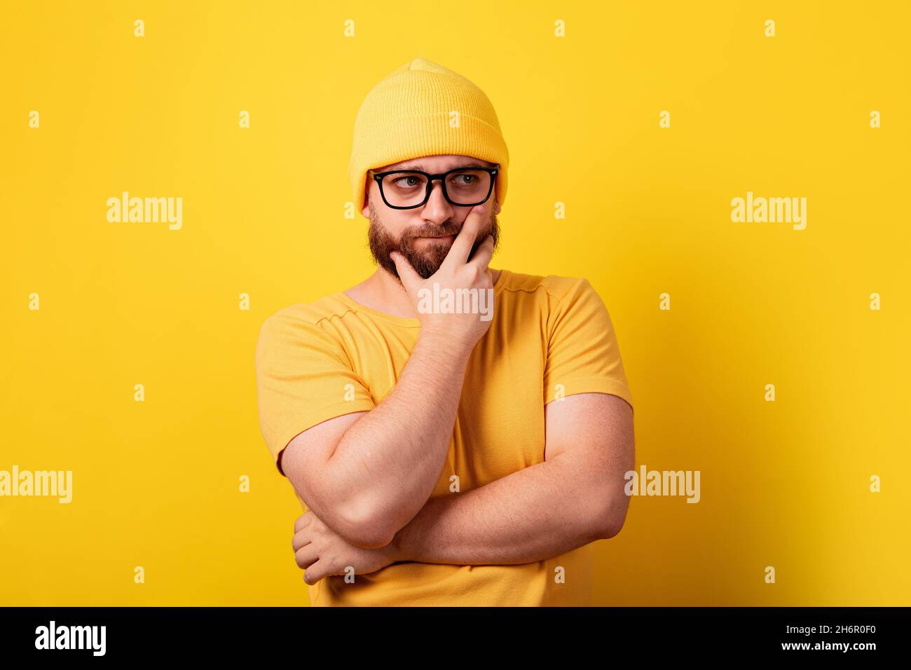 thinking man over yellow background, serious guy thinks Stock Photo - Alamy