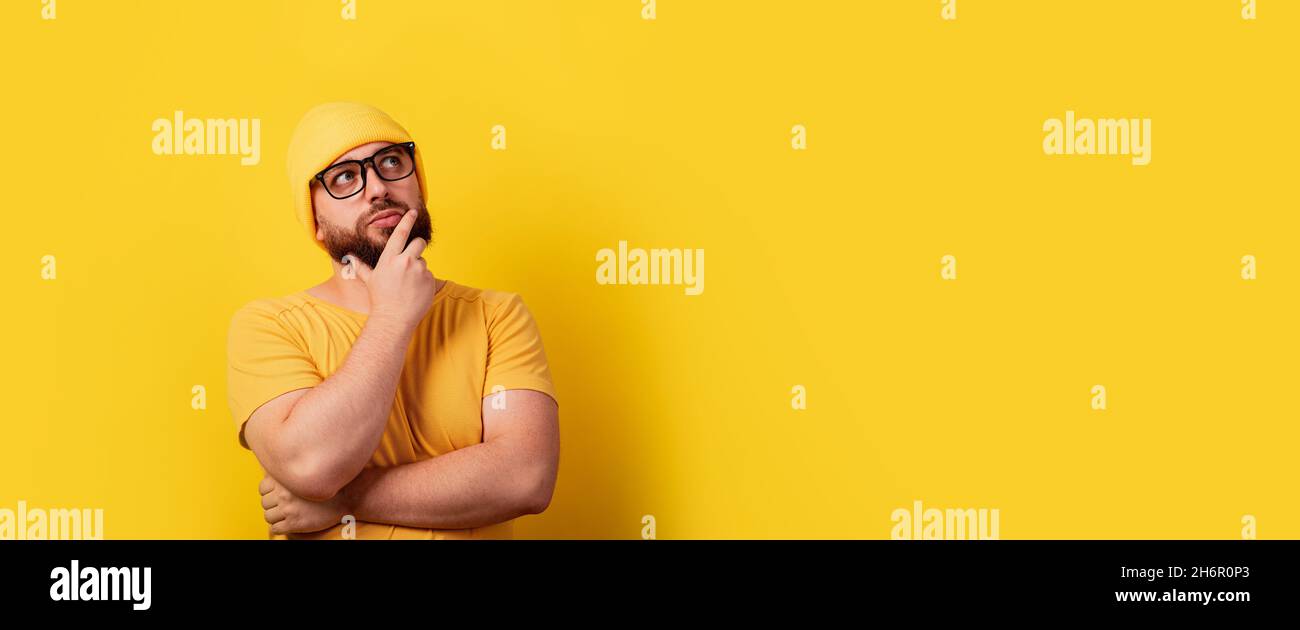 thinking man looks up over yellow background, panoramic layout Stock ...