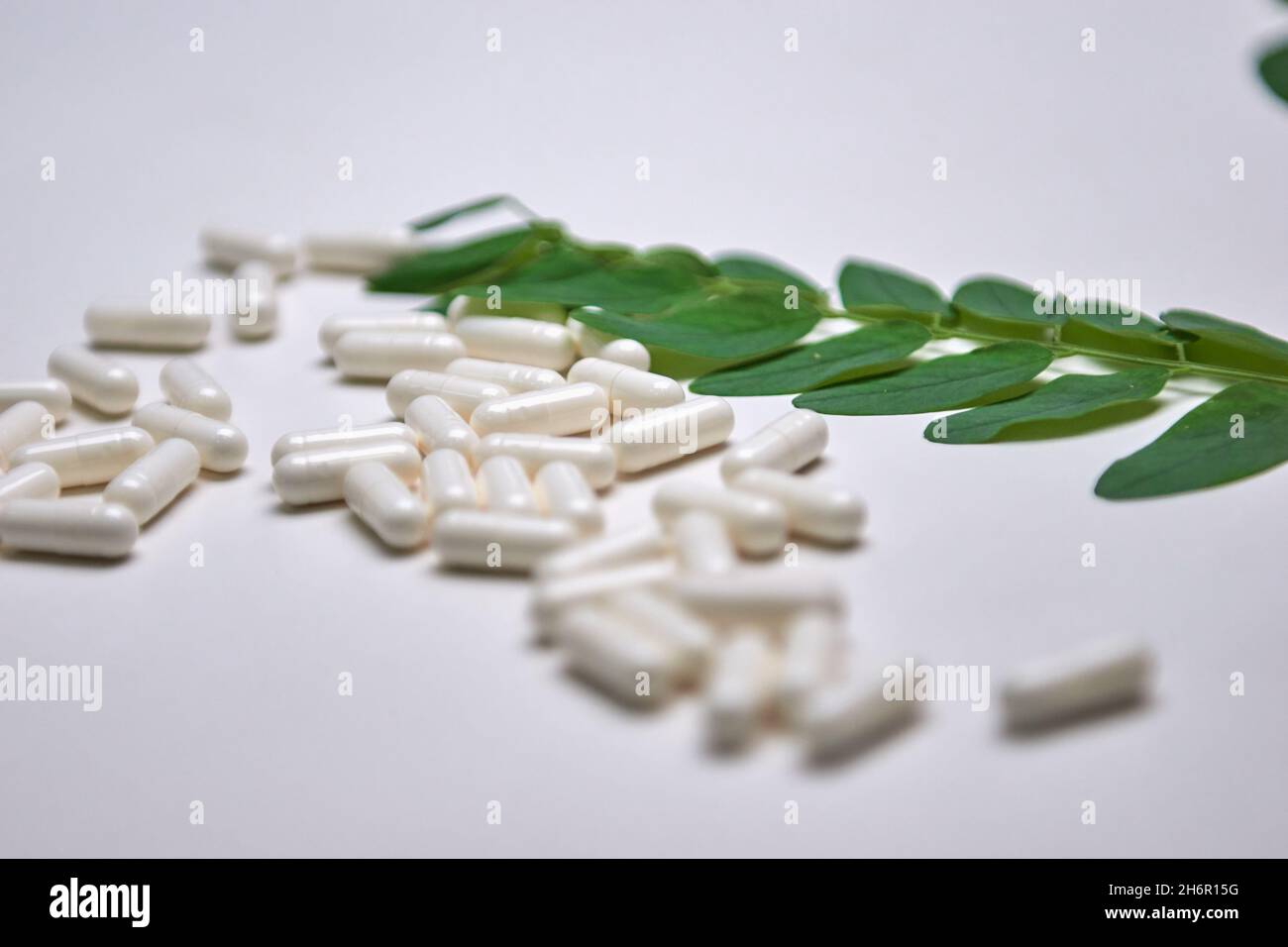 Many white capsule pills on a colorful background. Supplements and ...