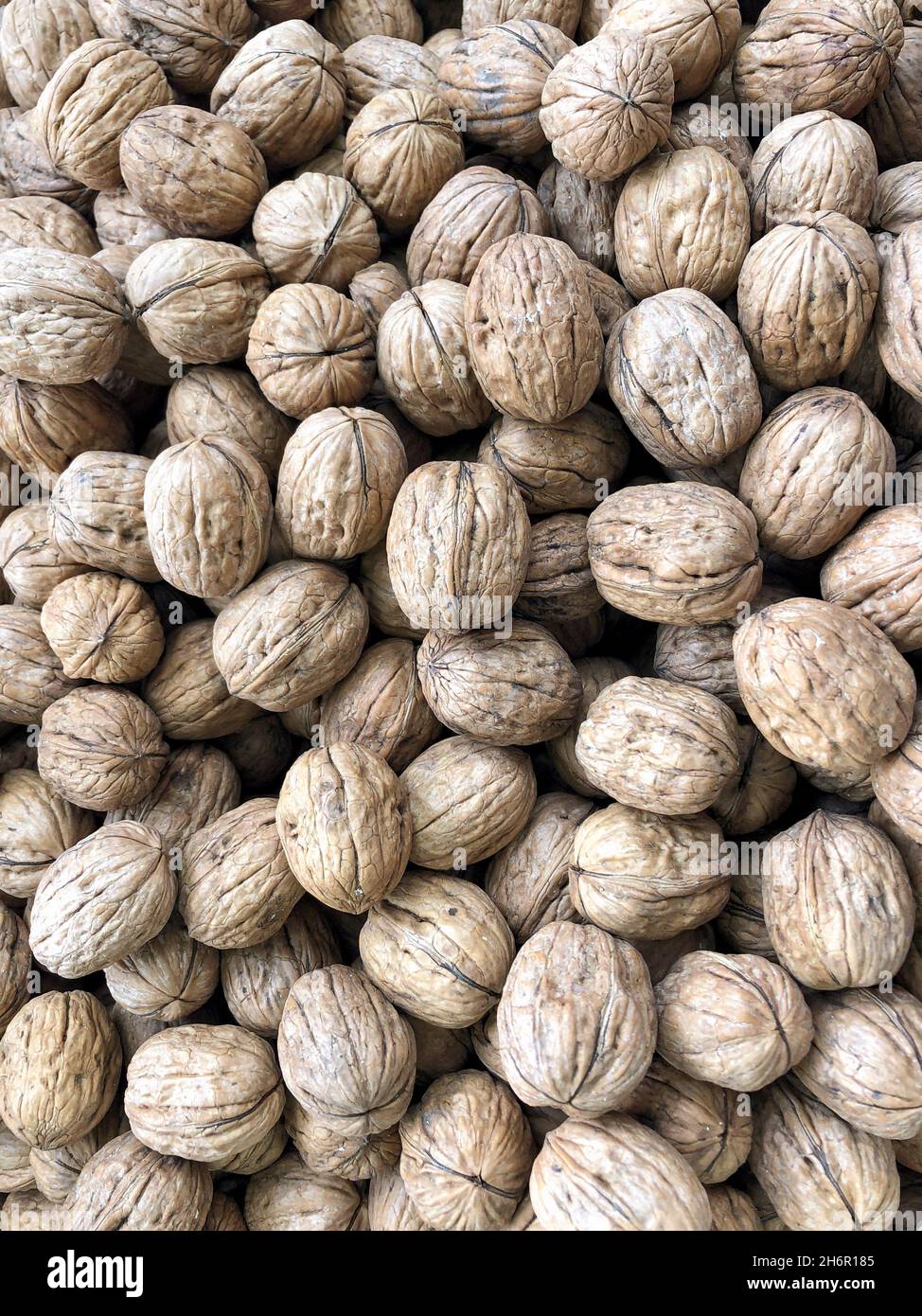 pile of whole walnuts with shells as a background Stock Photo - Alamy