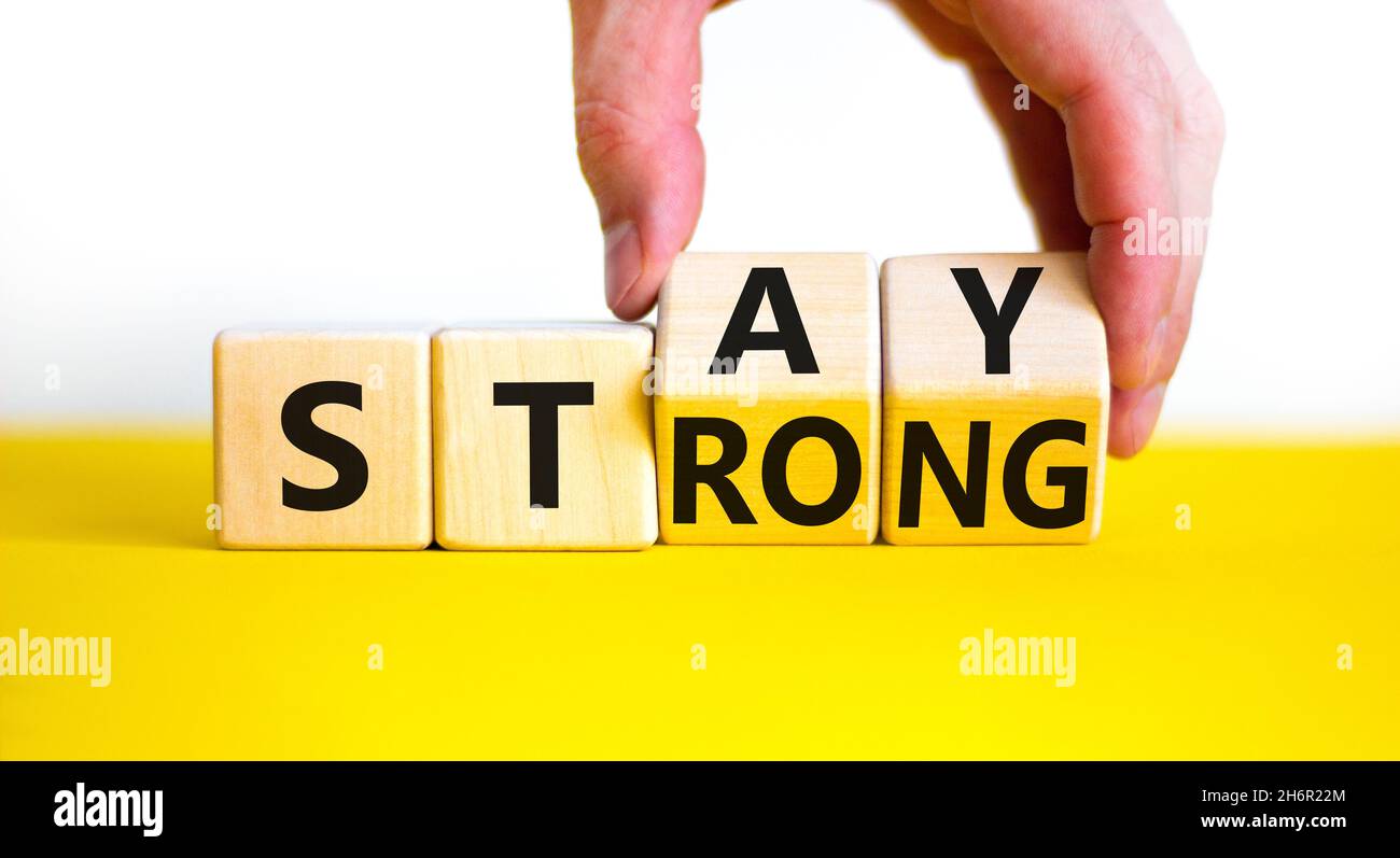 Stay strong symbol. Businessman turns cubes with words 'stay strong ...