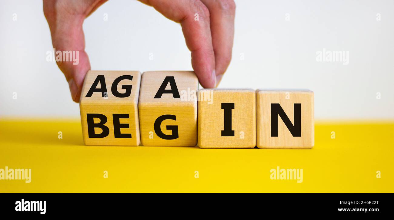 Begin again symbol. Businessman turns wooden cubes and changes the word ...