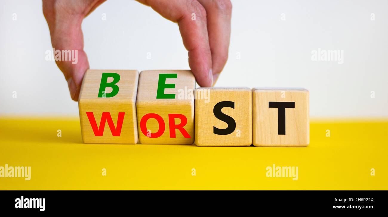 Best or worst symbol. Businessman turns wooden cubes and changes the ...