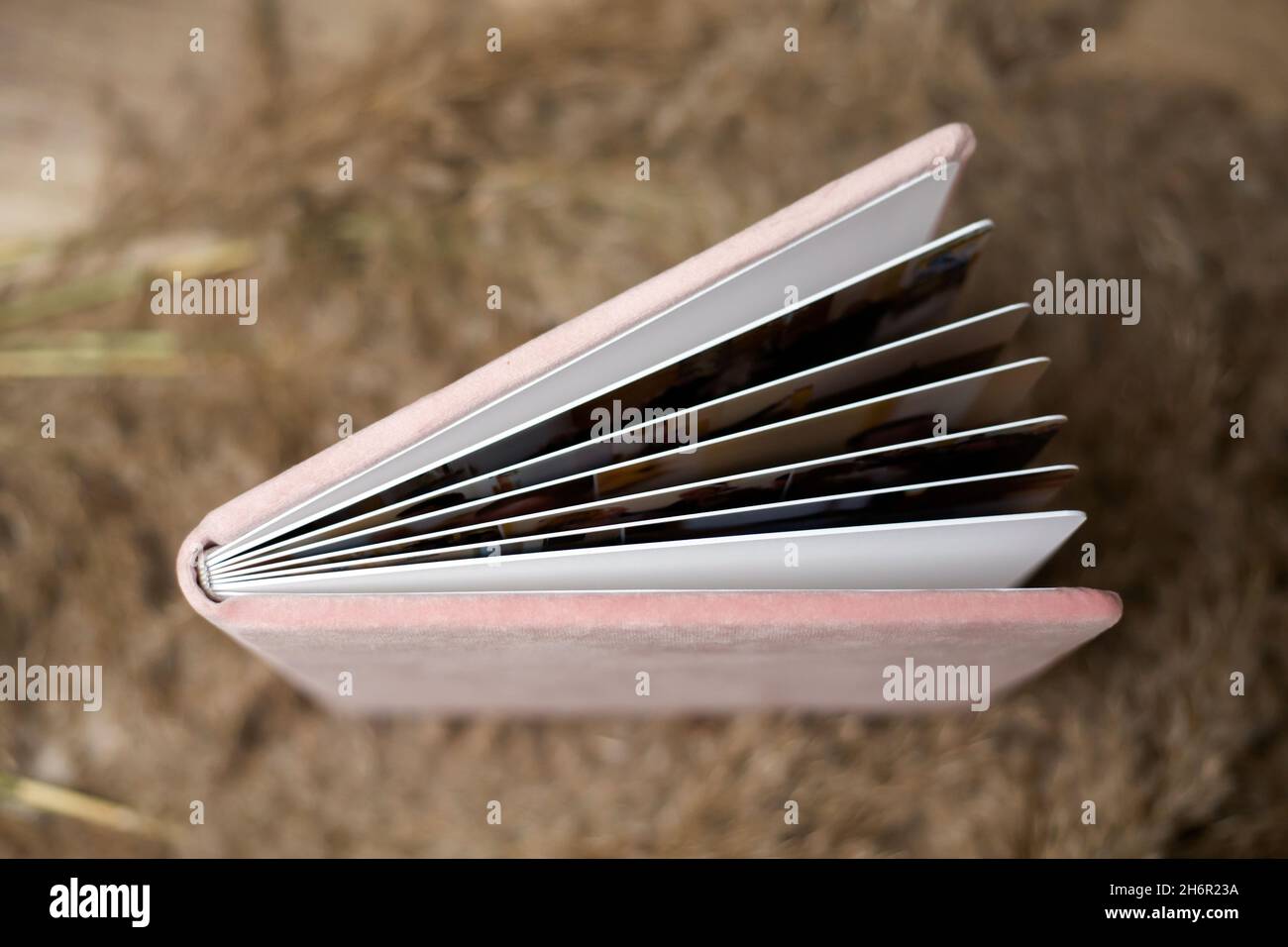 Closeup of opened exclusive photobook covered with velvet textile ...