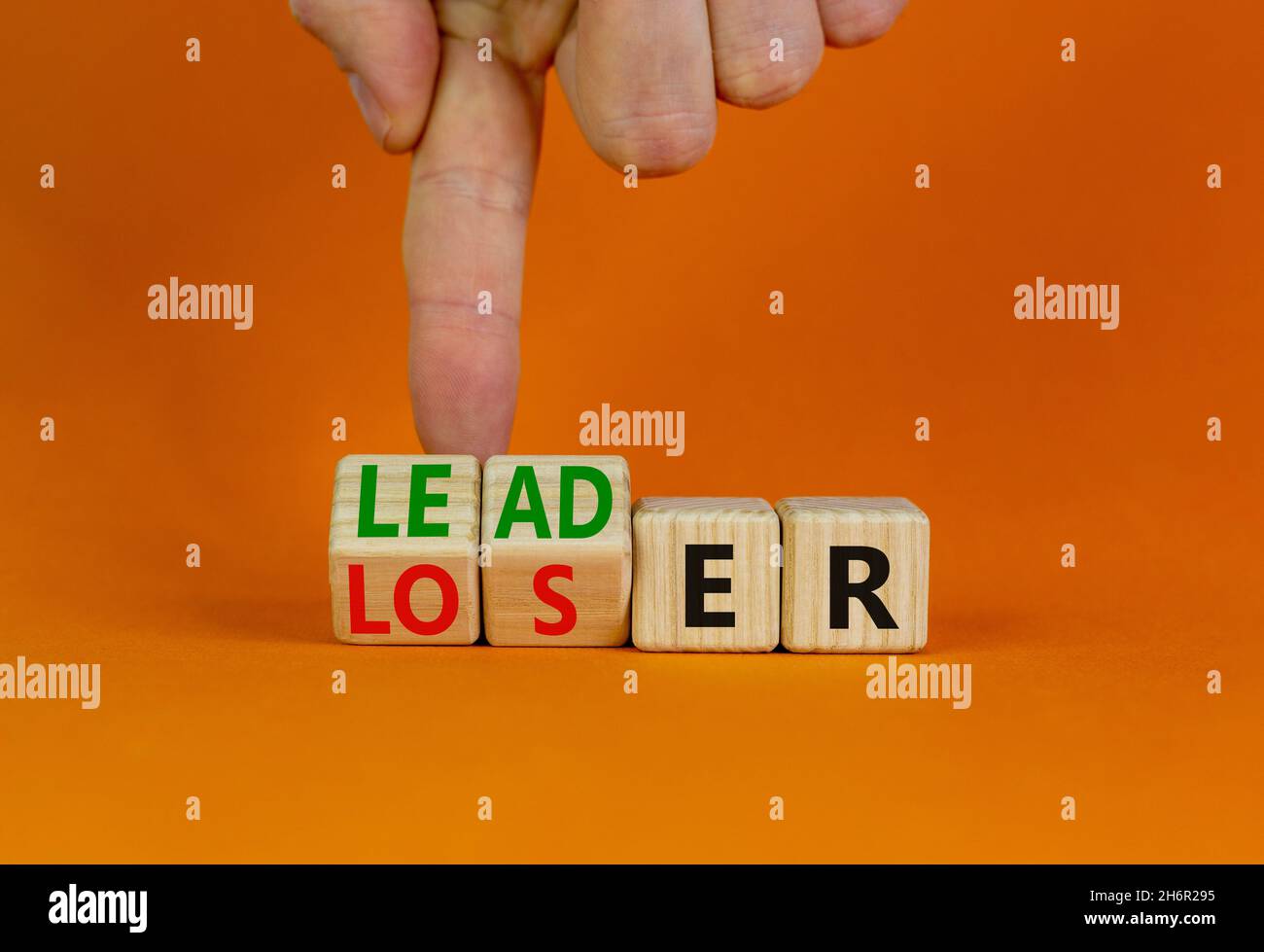 Loser or leader symbol. Businessman turns cubes and changes the word ...