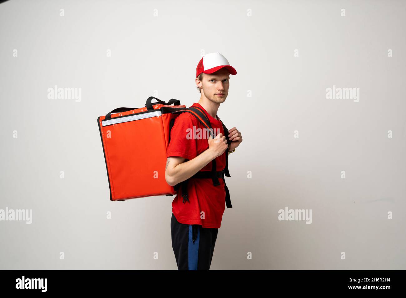 Portraite of delivery man in red t-shirt uniform thermal bag backpack ...