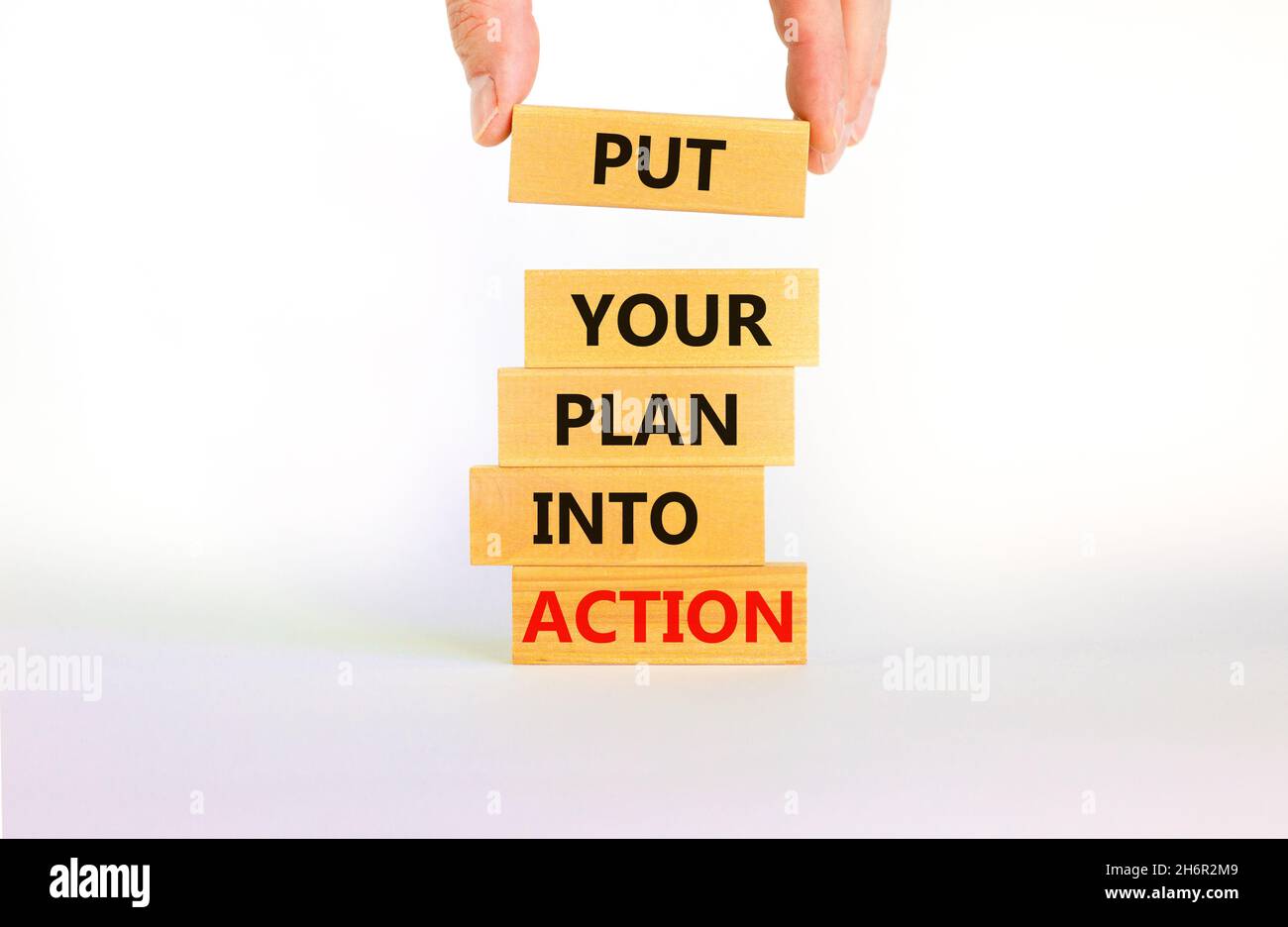 Put your plan into action symbol. Wooden blocks with words Put your ...