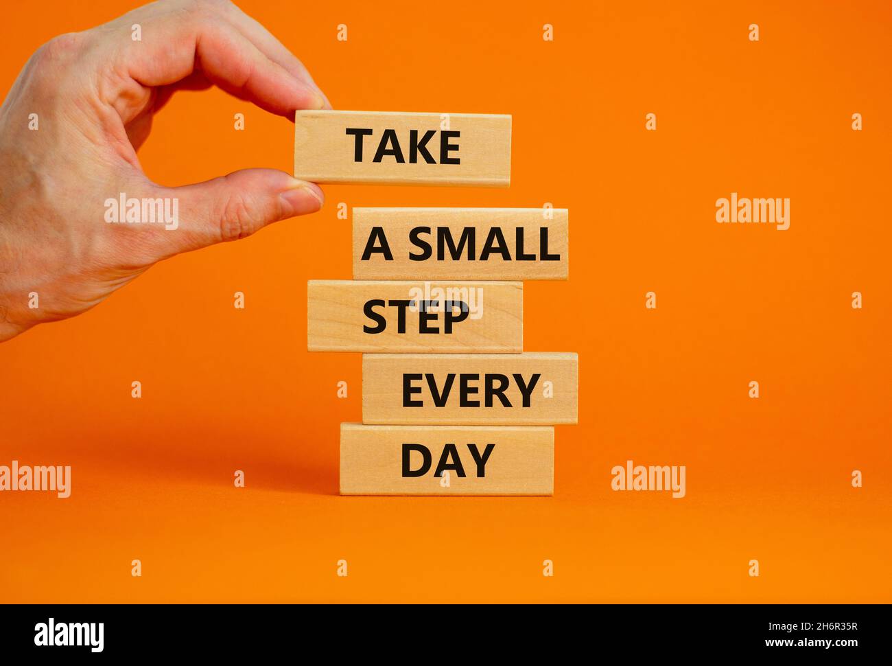 Take a small step every day symbol. Wooden blocks with words Take a ...