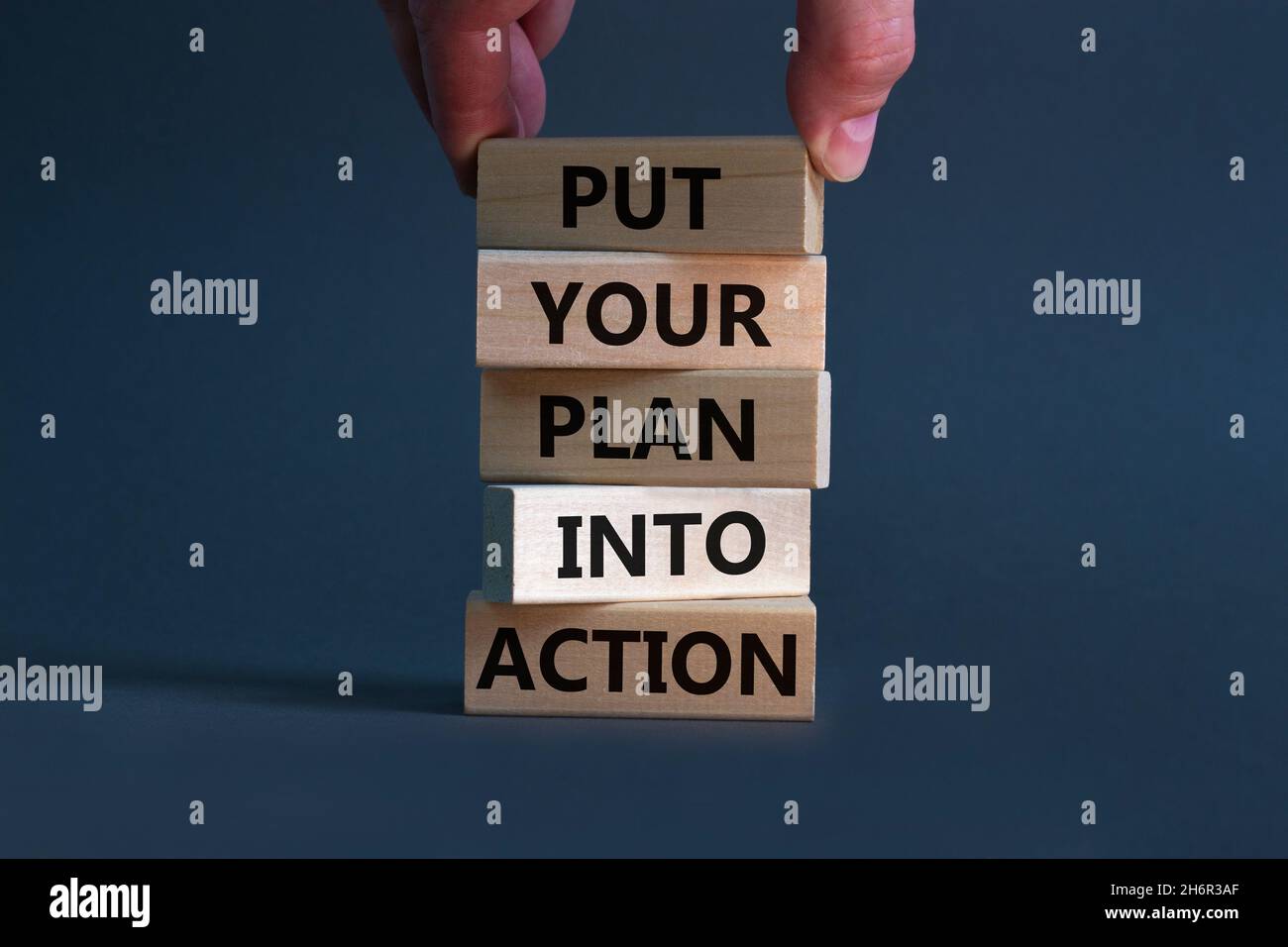 Put your plan into action symbol. Wooden blocks with words Put your ...