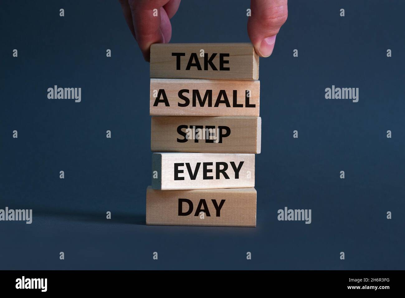 Take a small step every day symbol. Wooden blocks with words Take a ...