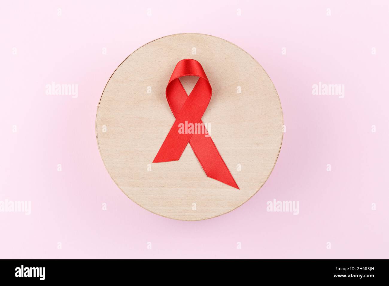 Red ribbon. Cancer control symbol Stock Photo - Alamy