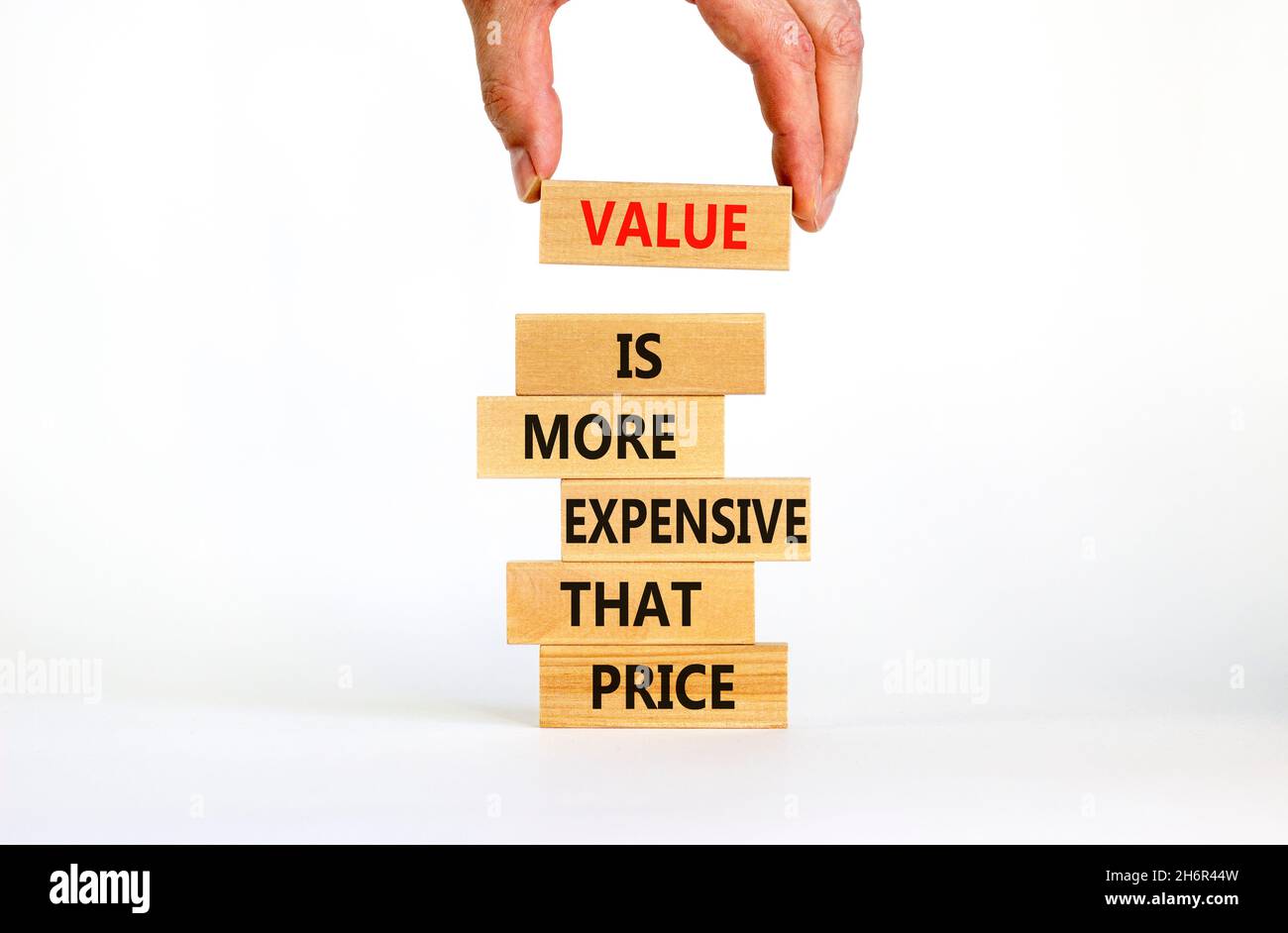 Price or value symbol. Wooden blocks with concept words Value is more ...