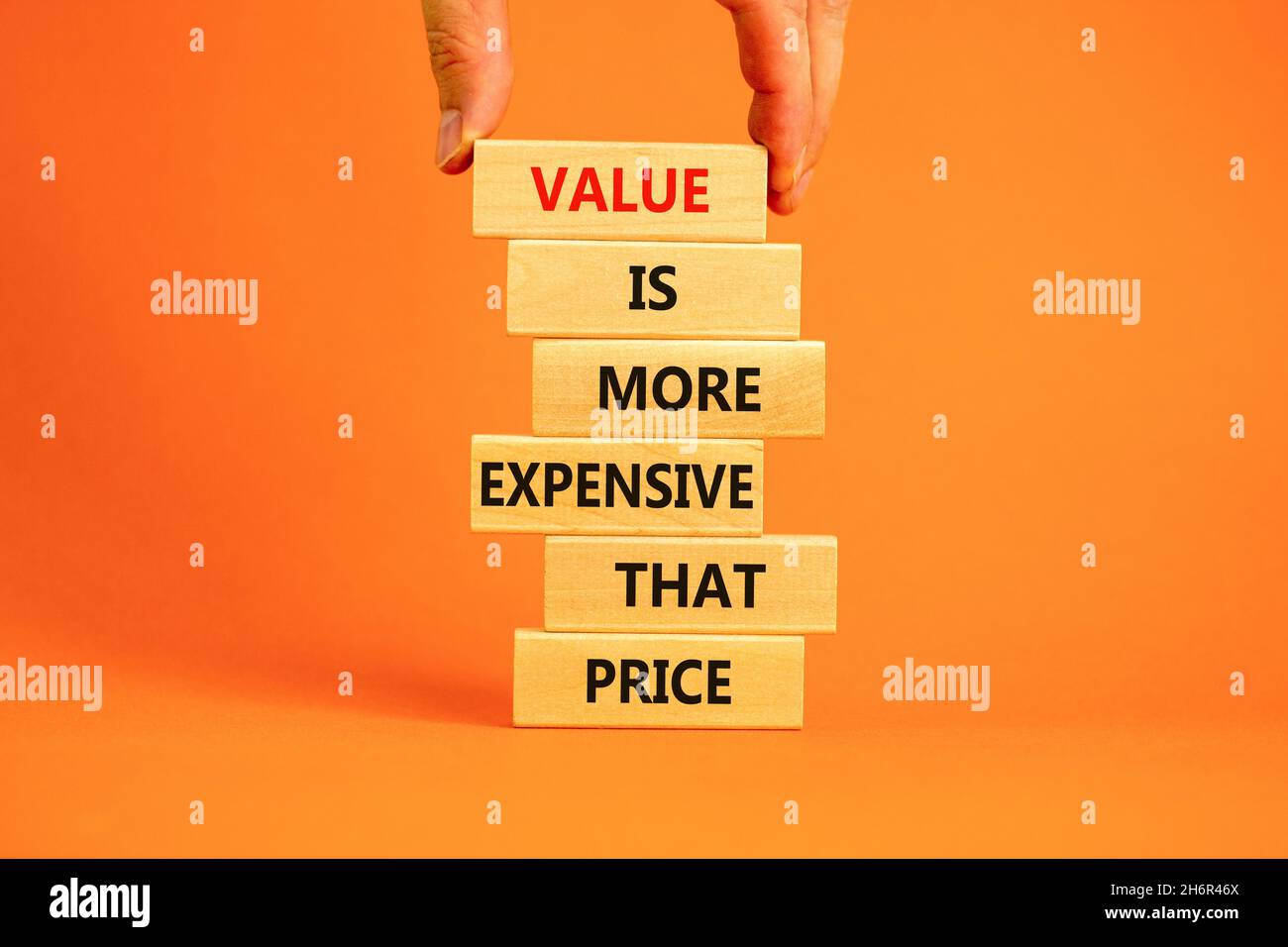 Price or value symbol. Wooden blocks with concept words Value is more ...