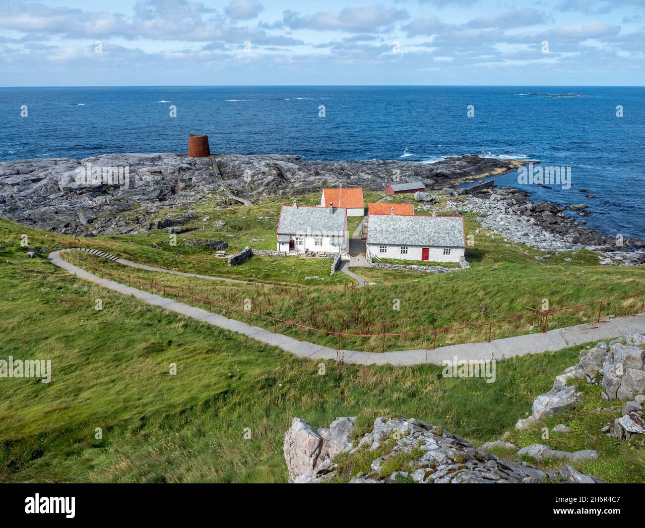 Lighthouse area, ruin of old lighthouse and houses at the coast of ...