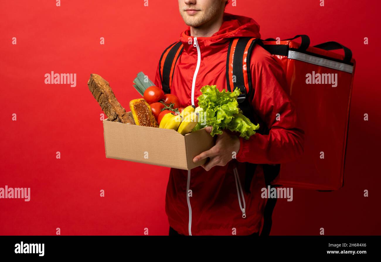 Delivery Concept - Handsome delivery man carrying package box of ...
