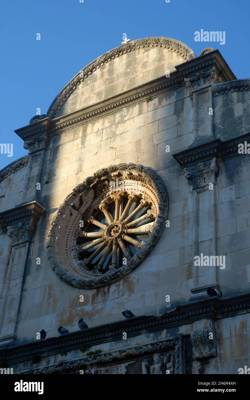 Round ornate window frame, Franciscan Monastery and City Bell Tower ...