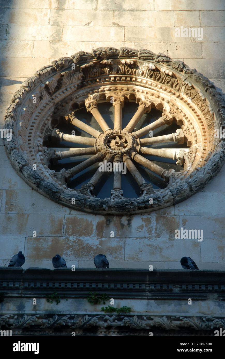 Round ornate window frame, Franciscan Monastery and City Bell Tower ...