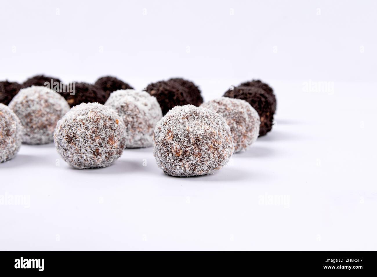 Sweet coconut and Swedish chocolate ball on white background. Selective ...