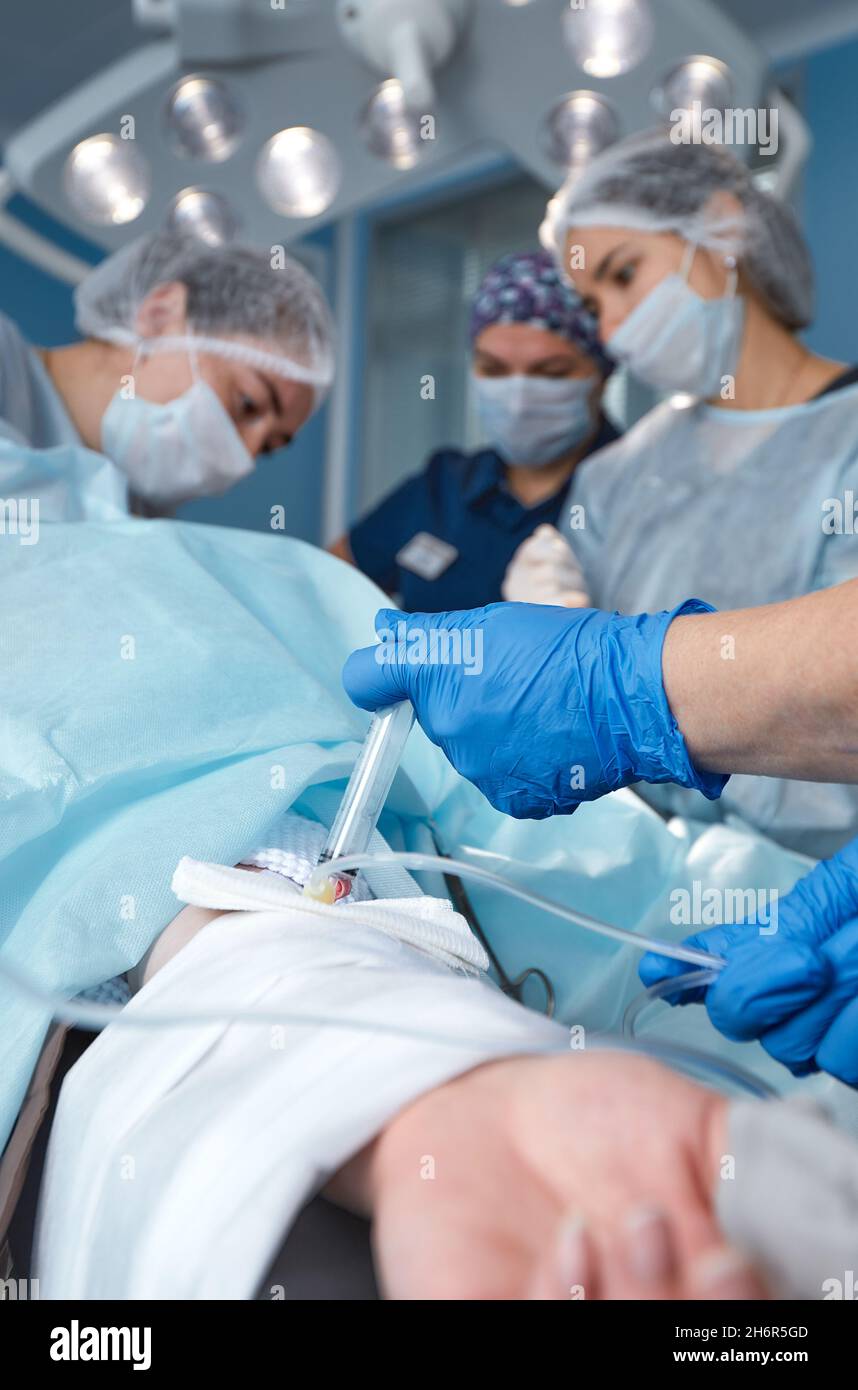 The patient's hand is under the IV with a pulse oximeter on the finger ...