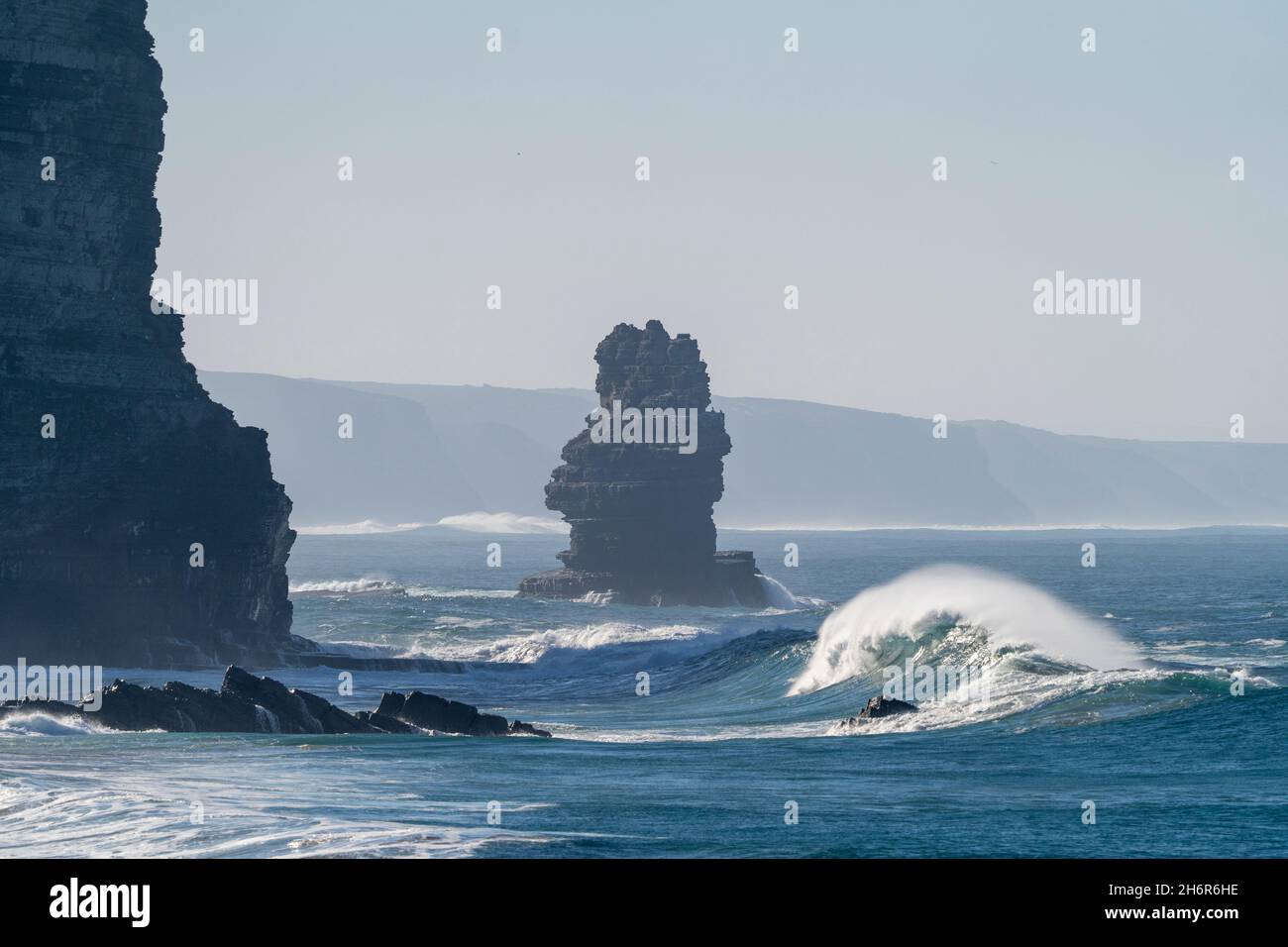 Perfect big wave breaking. Big surf near by the rocks in the sea ...