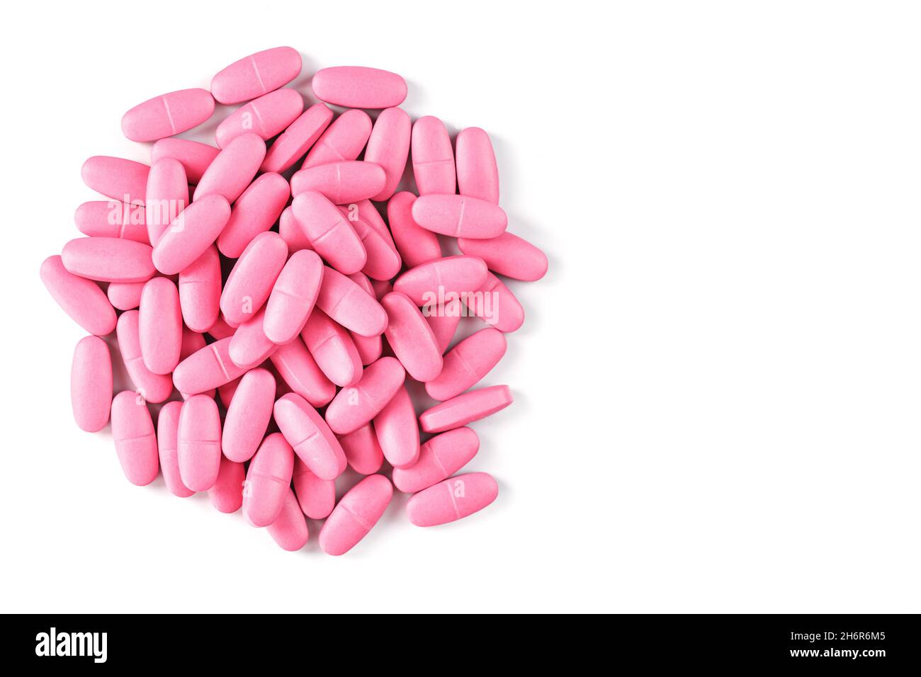 Pink vitamin pills for women on a white background. Multivitamins for ...