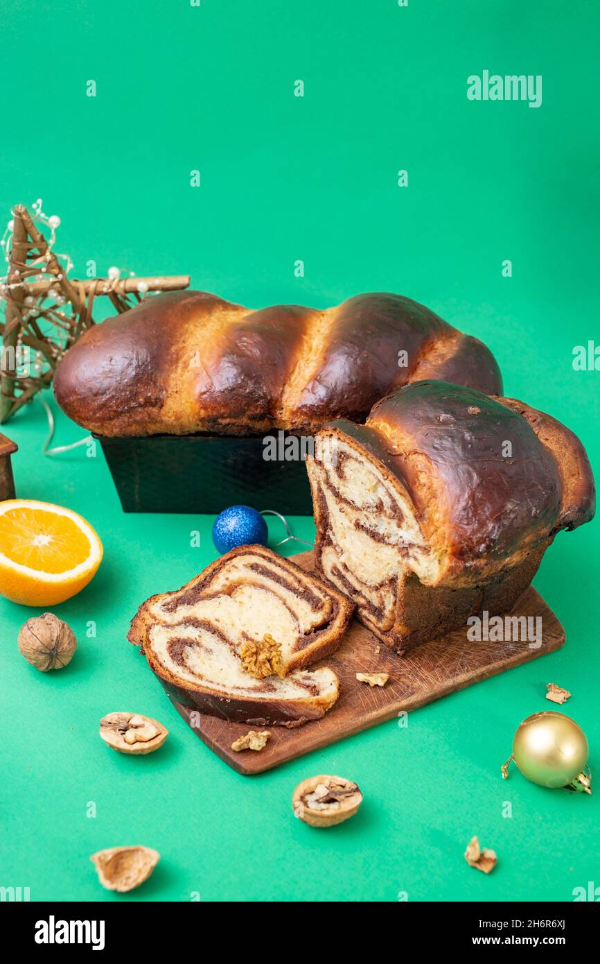 Romanian traditional sweet bread named "cozonac", on green background ...