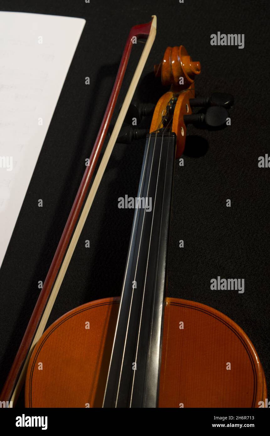 Wooden violin with its bow on black background Stock Photo - Alamy