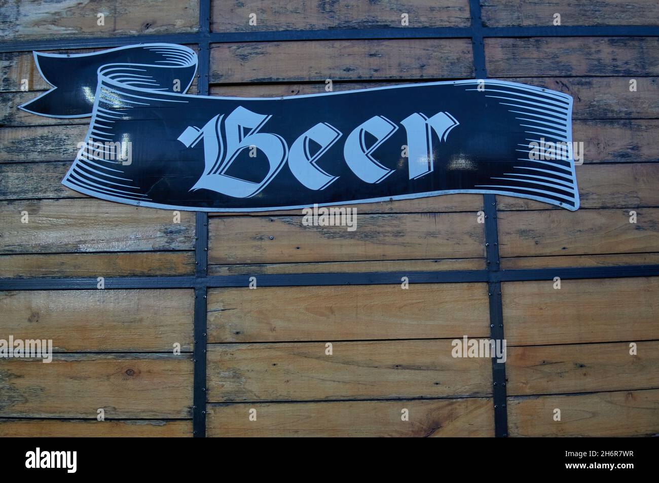 wooden wall with a black sign that says beer in white in a brewery yard ...