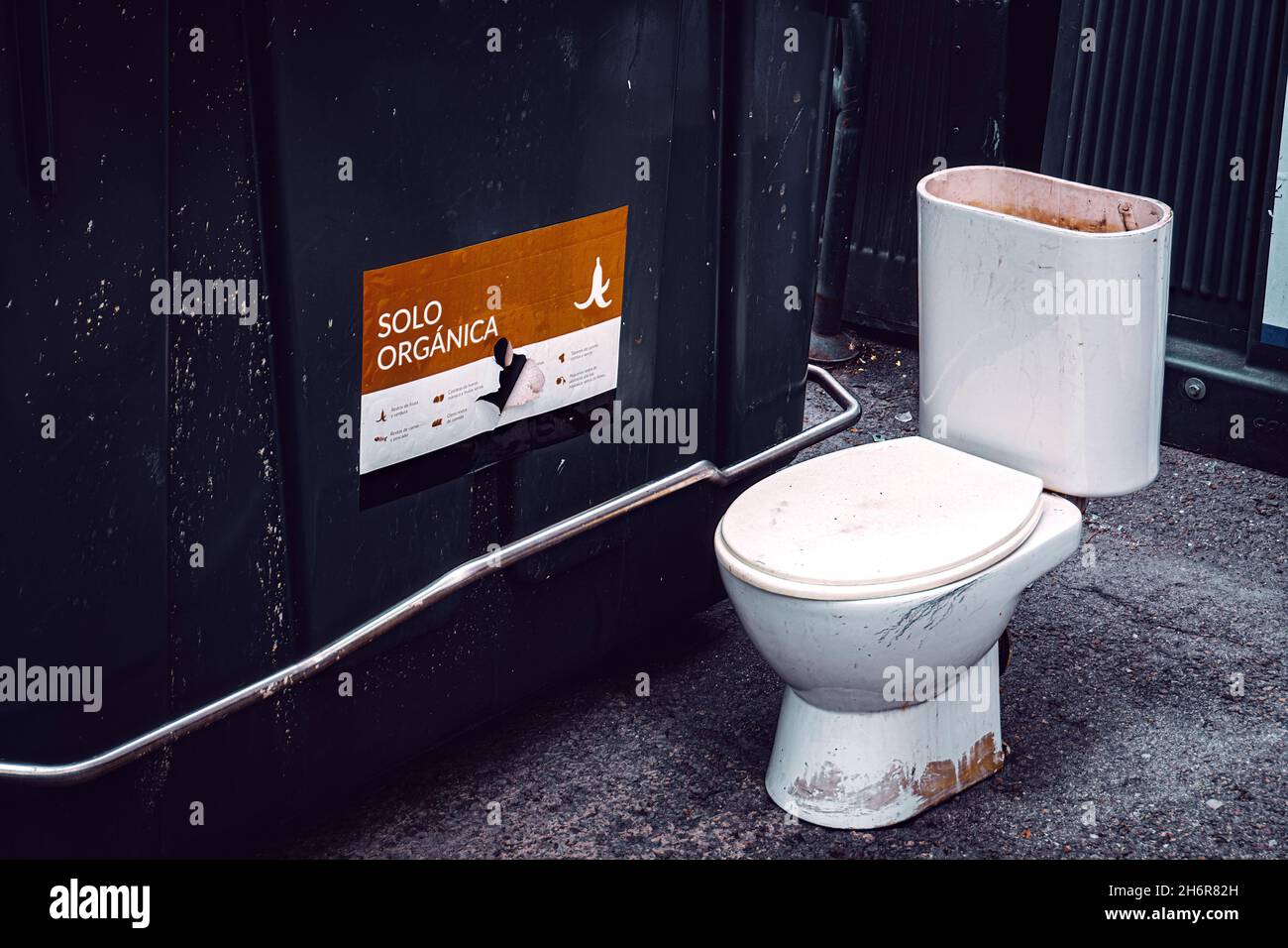 The toilet bowl of white color threw out on the street at a garbage ...