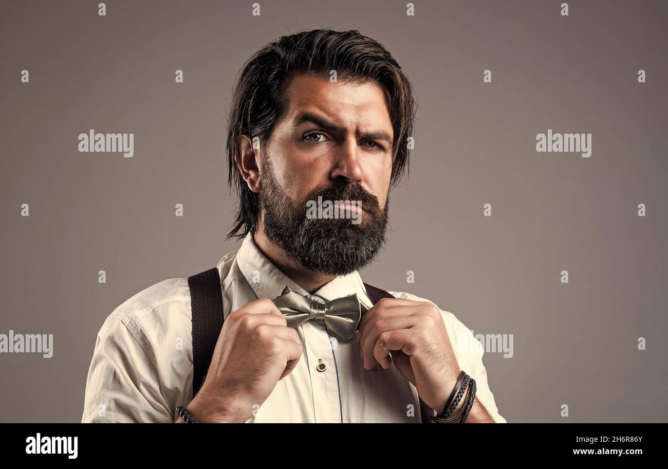 formal man wear suspenders and fix bow tie has well groomed hair and ...