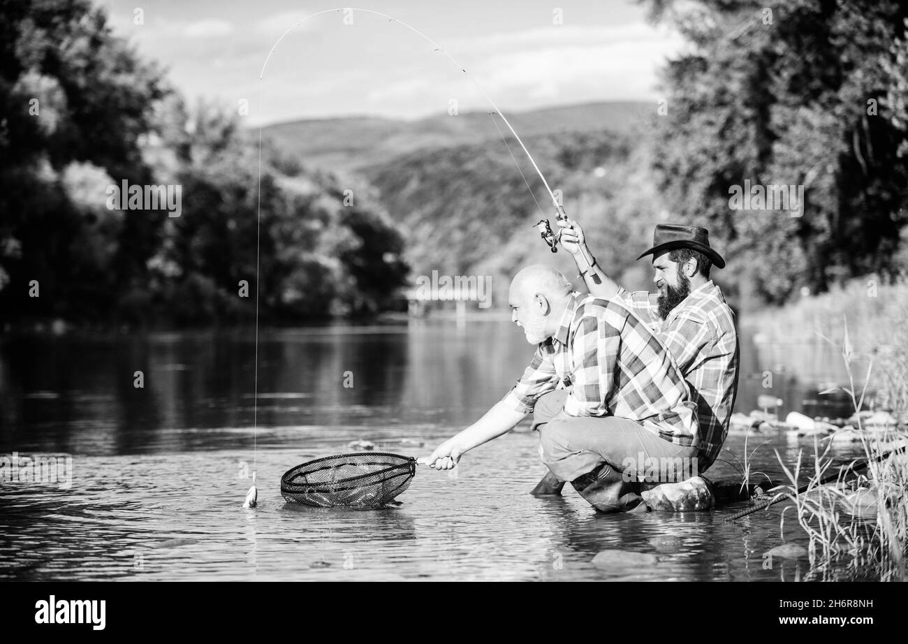 Autumn fishing spinning. Two male friends fishing together. retired dad ...