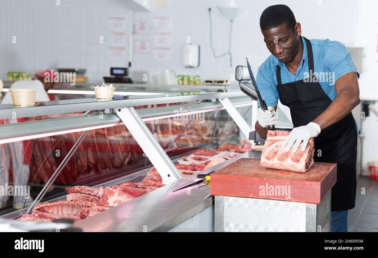 Positive butcher cutting meat hi-res stock photography and images - Alamy