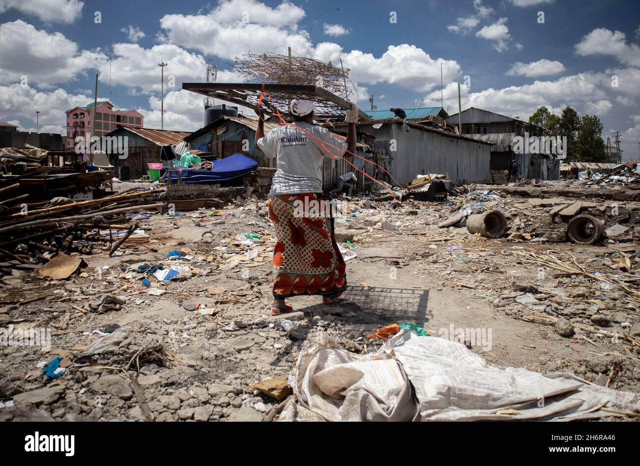 Nairobi, Kenya. 17th Nov, 2021. A woman relocates with carrying her bed ...