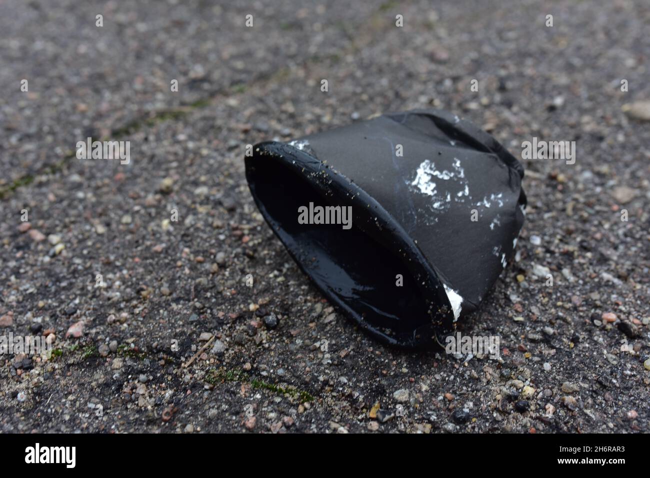 Crumpled a paper coffee cup on asphalt. Discarded disposable coffee cup ...