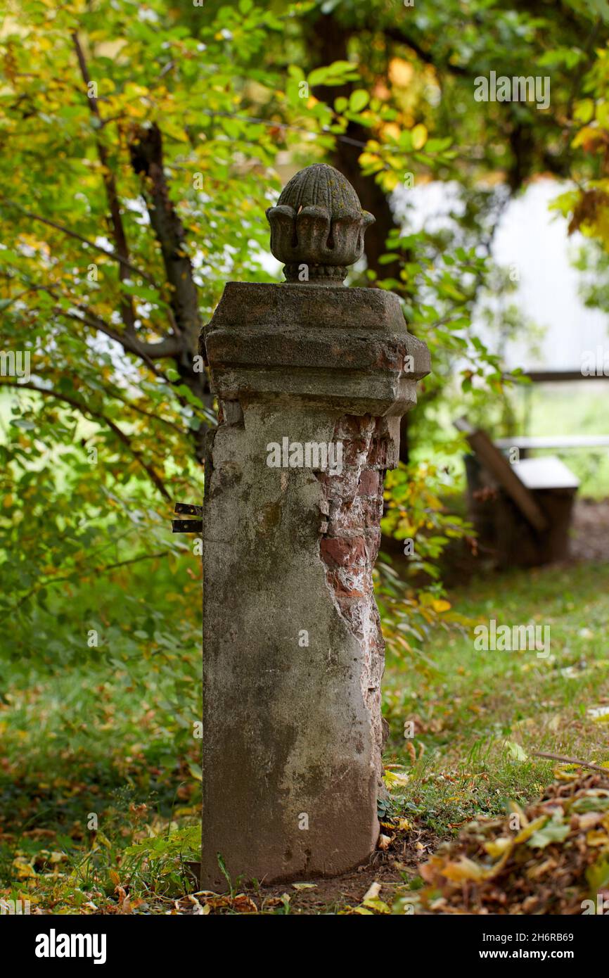 fretwork on column Vase on column in red bricks Garden with tall poplar ...