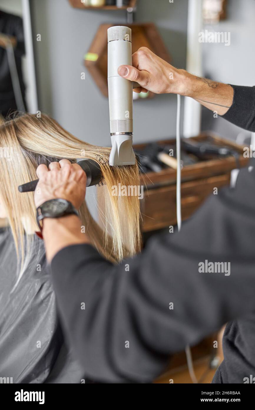 Hair drying process in modern hairdresser's salon Stock Photo - Alamy