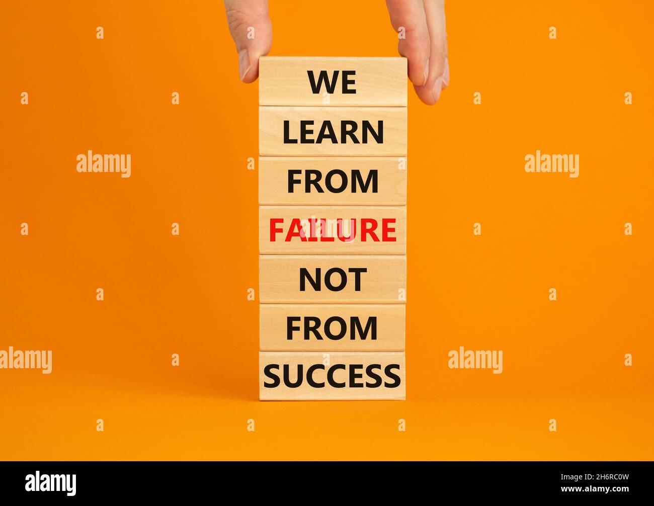 Failure or success symbol. Wooden blocks with words We learn from ...
