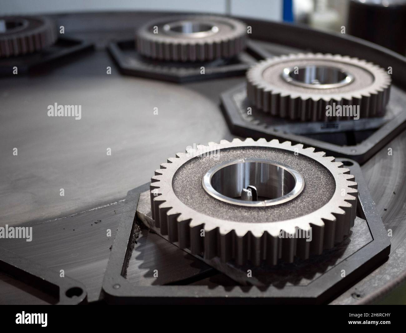Tractor gears on the vertical lathe, close up. Manufacture of cogwheels ...