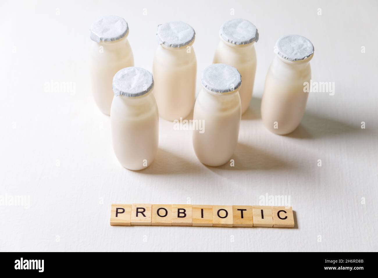 Small bottles with probiotics and prebiotics dairy drink on white ...