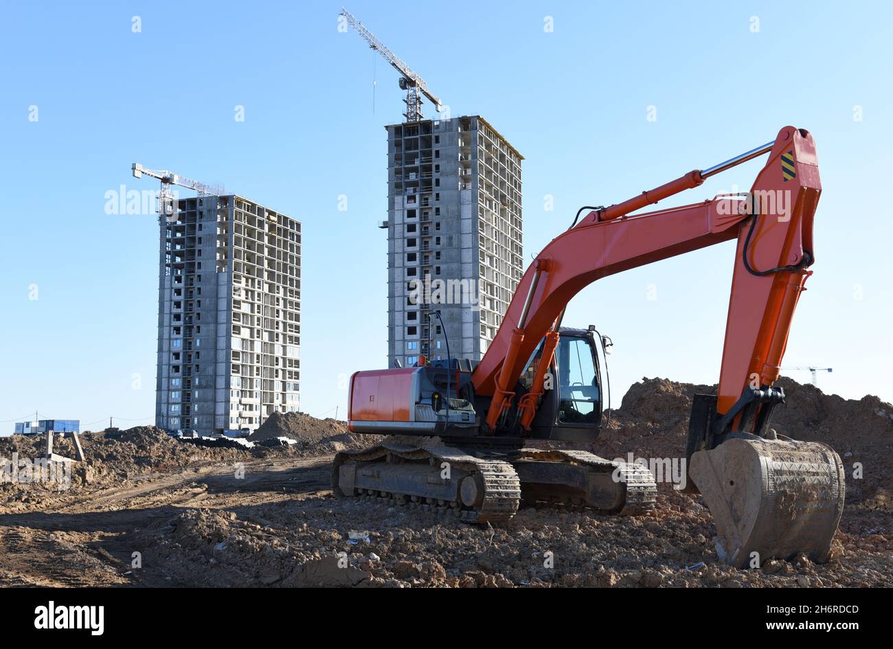 Excavator working at construction site. Backhoe on road work and ...