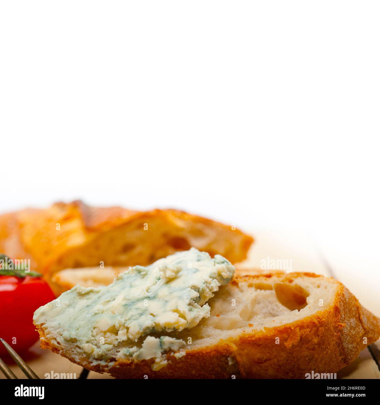 fresh blue cheese spread ove french baguette with cherry tomatoes on ...