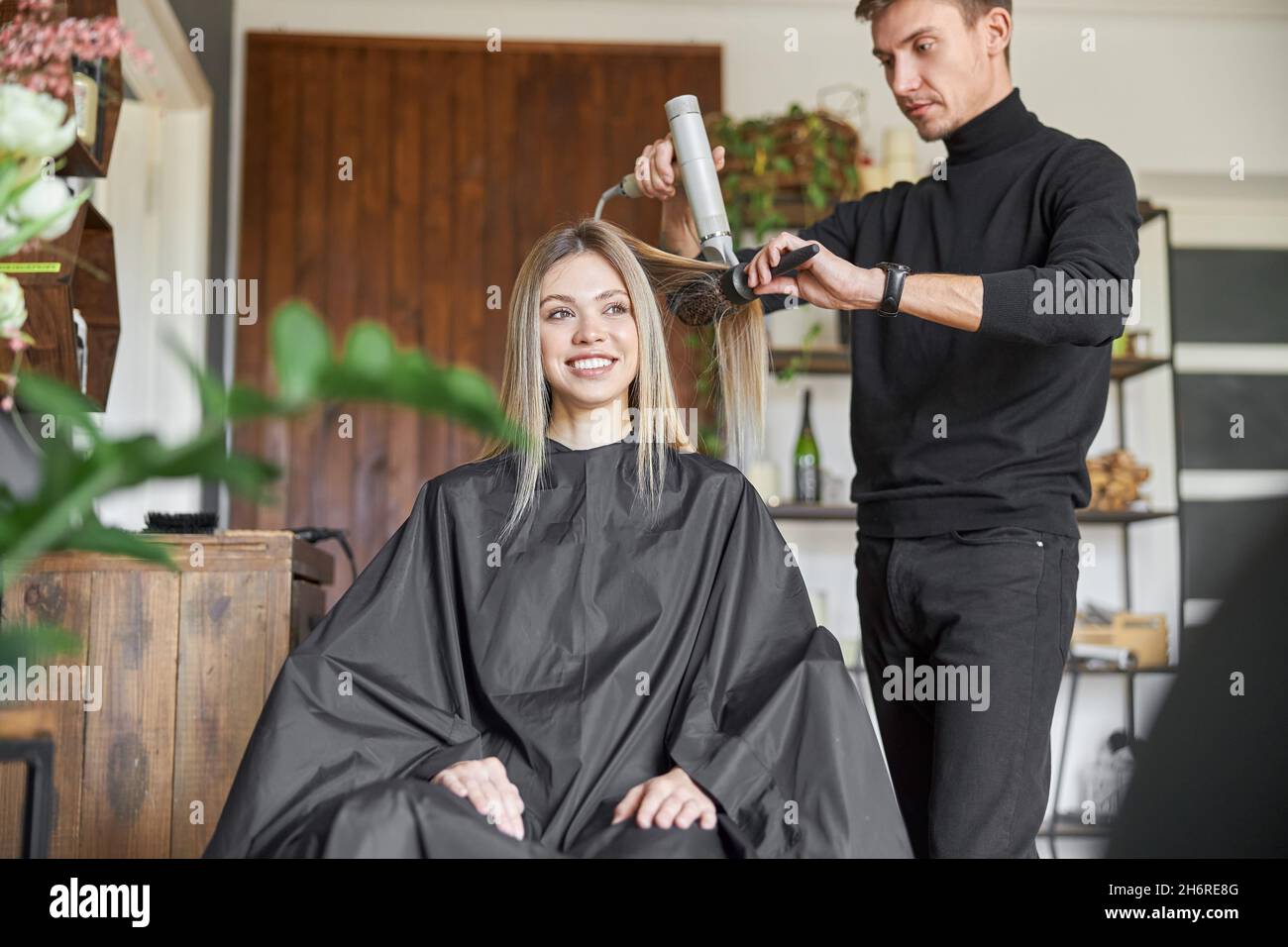 Hair drying process in modern hairdresser's salon Stock Photo - Alamy
